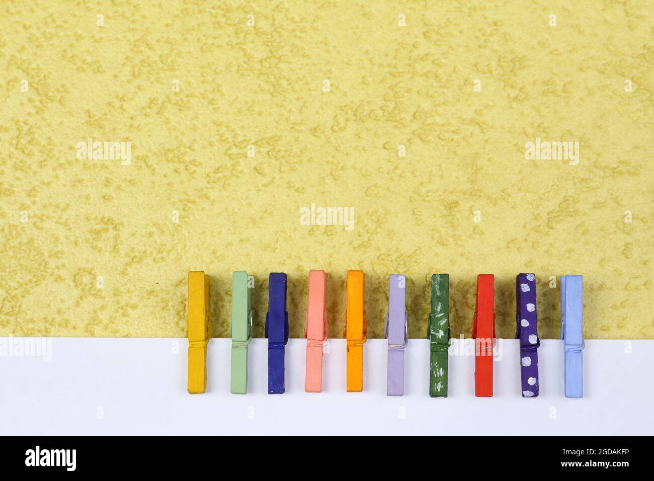 Abstract background with colorful wooden pins and paper Stock Photo - Alamy