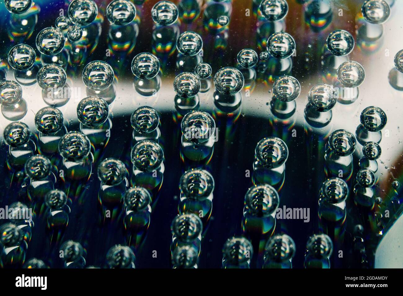 A selective focus shot of beautiful soda bubbles on a reflective disk ...