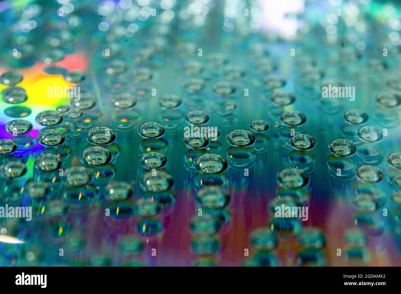 A selective focus shot of beautiful soda bubbles on a reflective disk ...