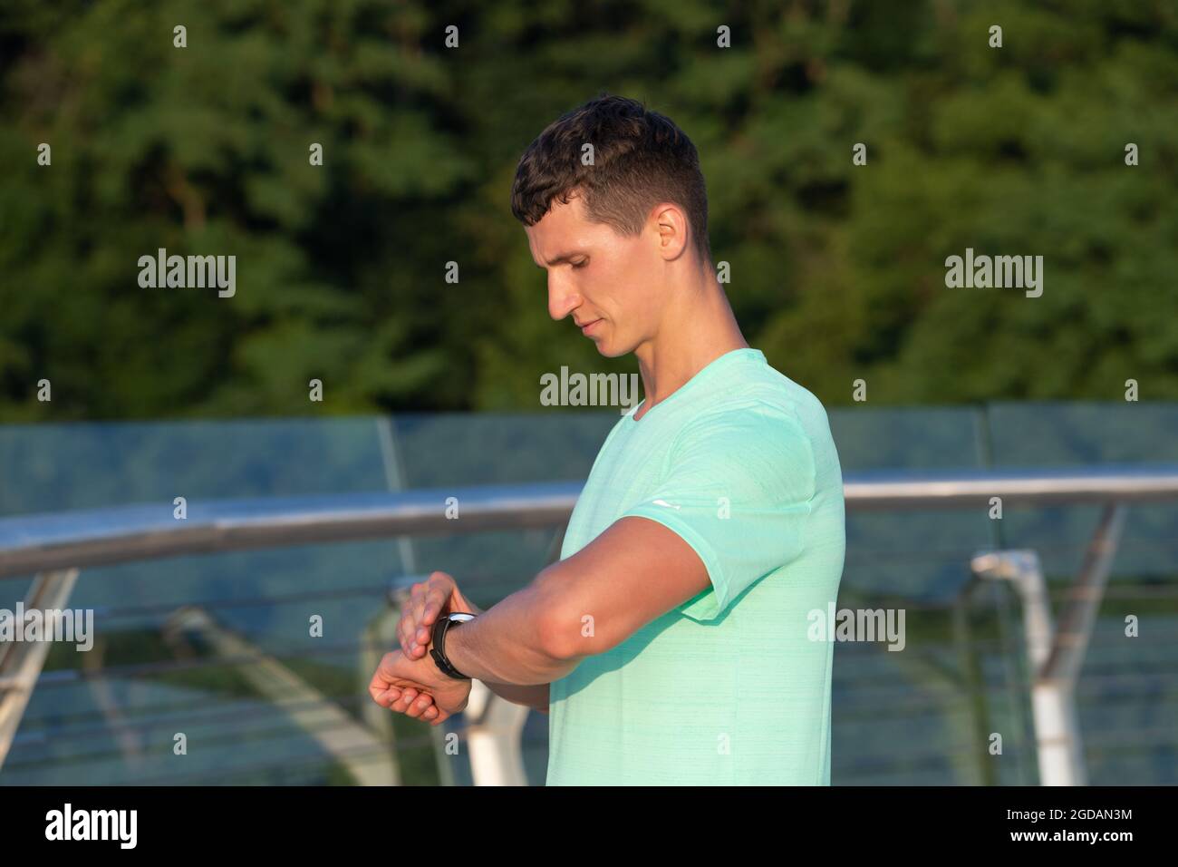 Analysing his result. Man check time on watch after workout. Exercise ...