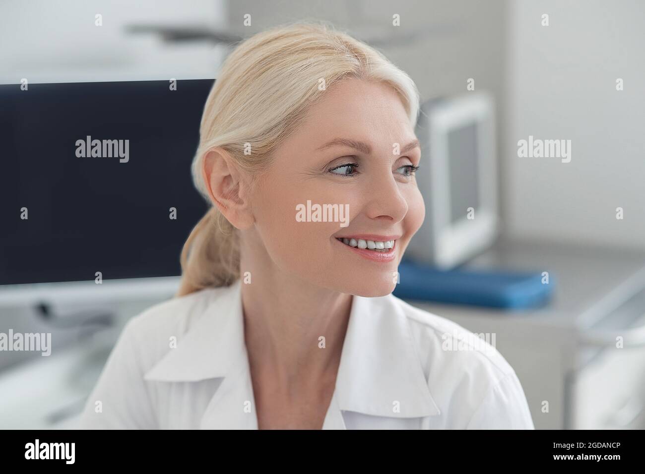 A good-looking female doctor smiling nicely Stock Photo - Alamy
