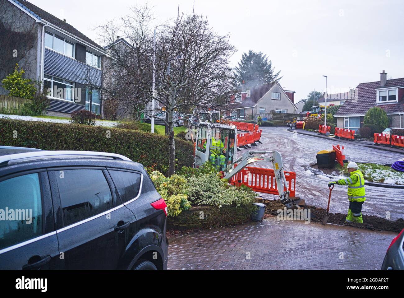 Digging up existing pavement for new cabling, laying, broadband ...