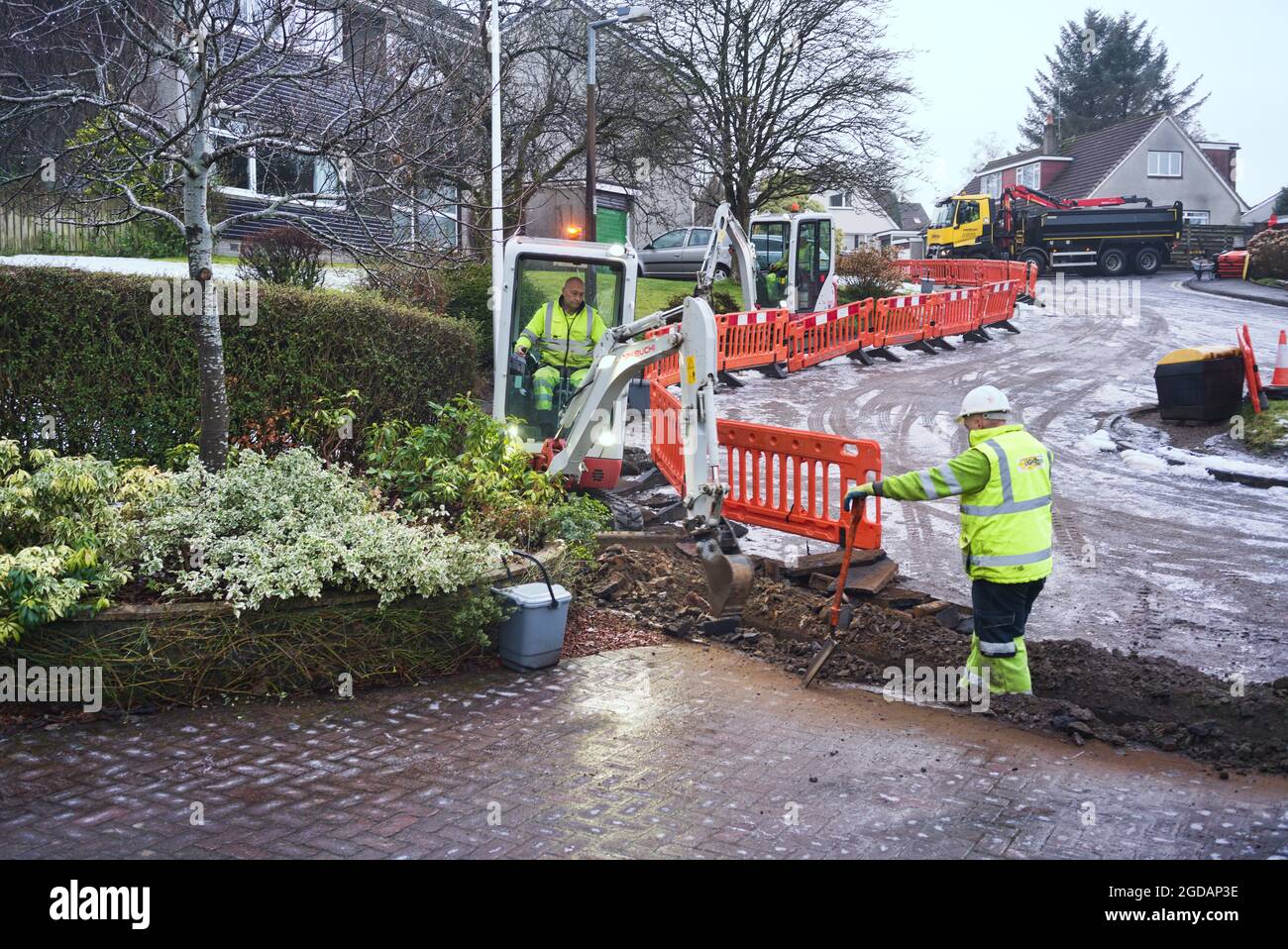 Digging up existing pavement for new cabling, laying, broadband ...