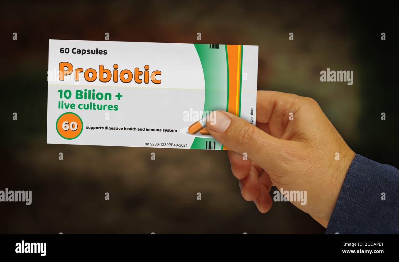 Probiotic pack production. Medical antibiotic therapy drug box in hand ...