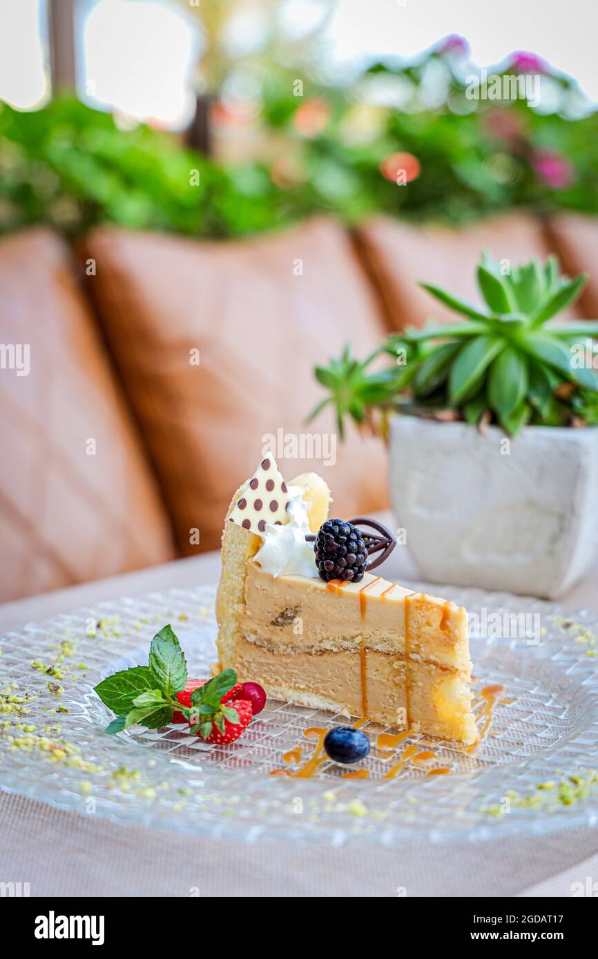 Vertical shot of a delicious slice of cake with fruits on top of it on ...