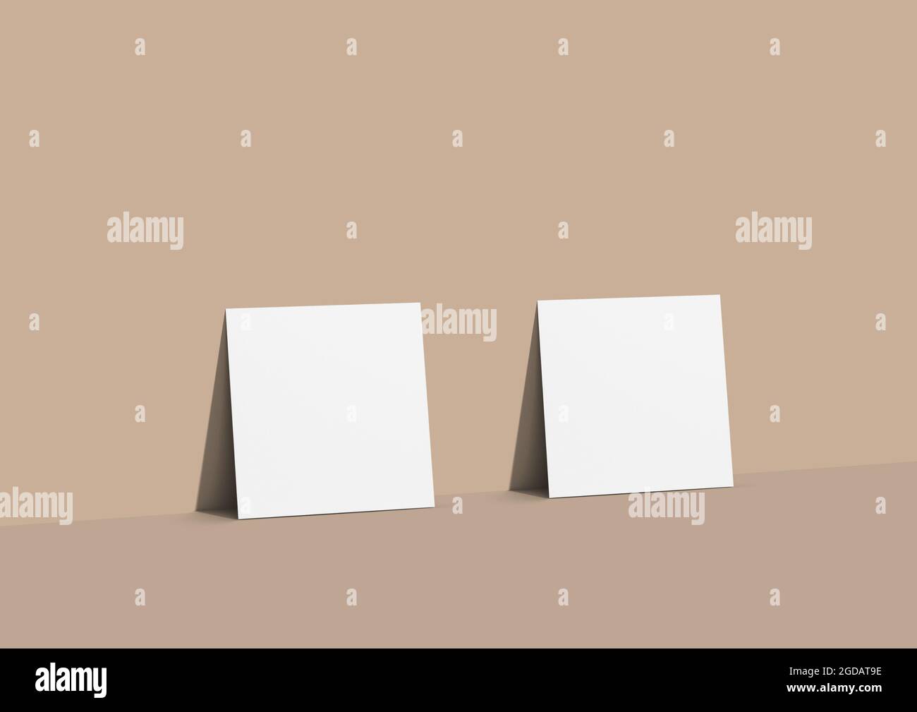 3D rendering of two pieces of square paper leaned against a brown wall ...