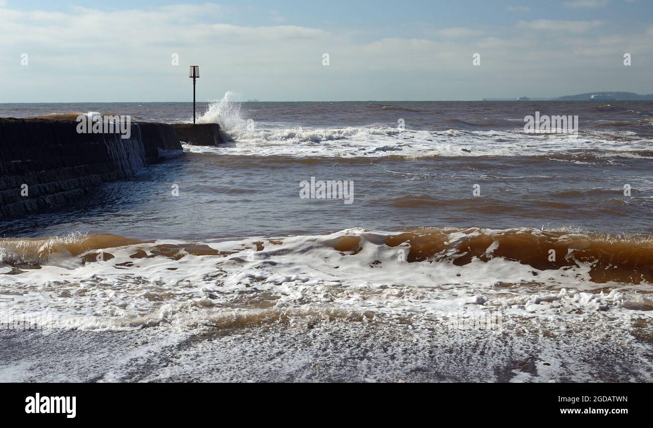 Waves breaking on the beach and breakwater at Dawlish, South Devon ...