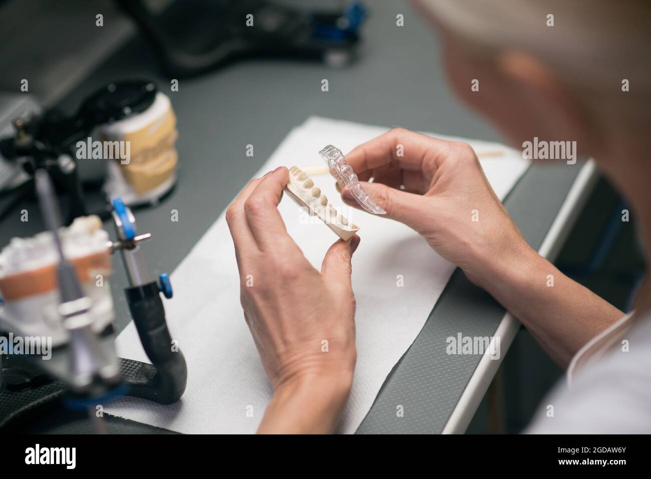 Dental prothetist. Close up picture of hands with dental prosthesis ...