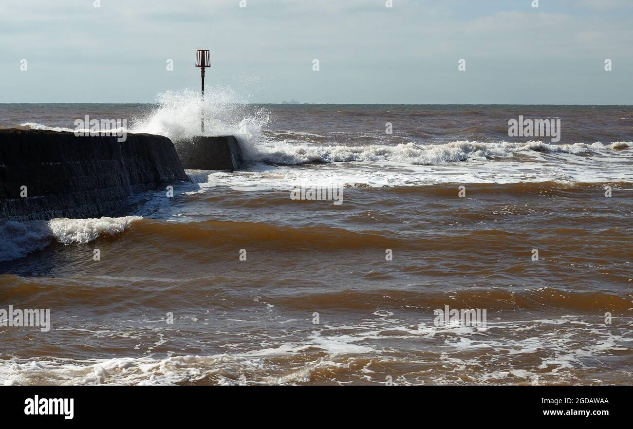 Waves breaking on the beach and breakwater at Dawlish, South Devon ...