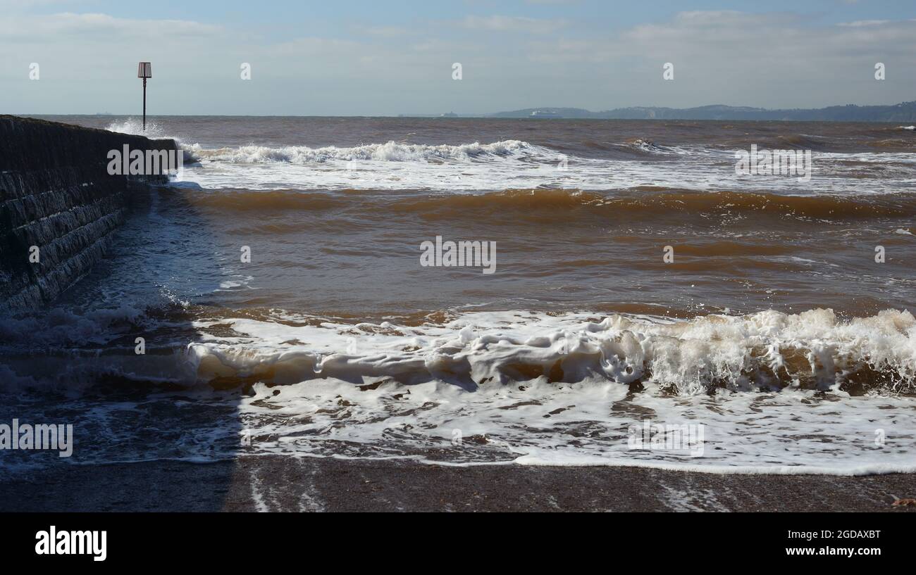 Waves breaking on the beach and breakwater at Dawlish, South Devon ...