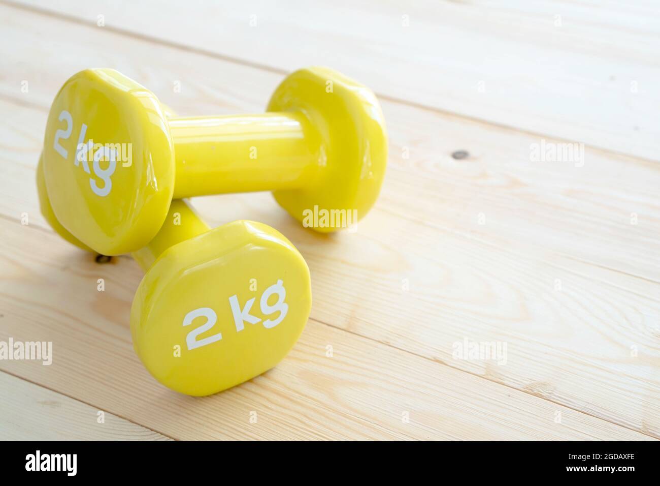 Small dumbbells on the floor Stock Photo - Alamy
