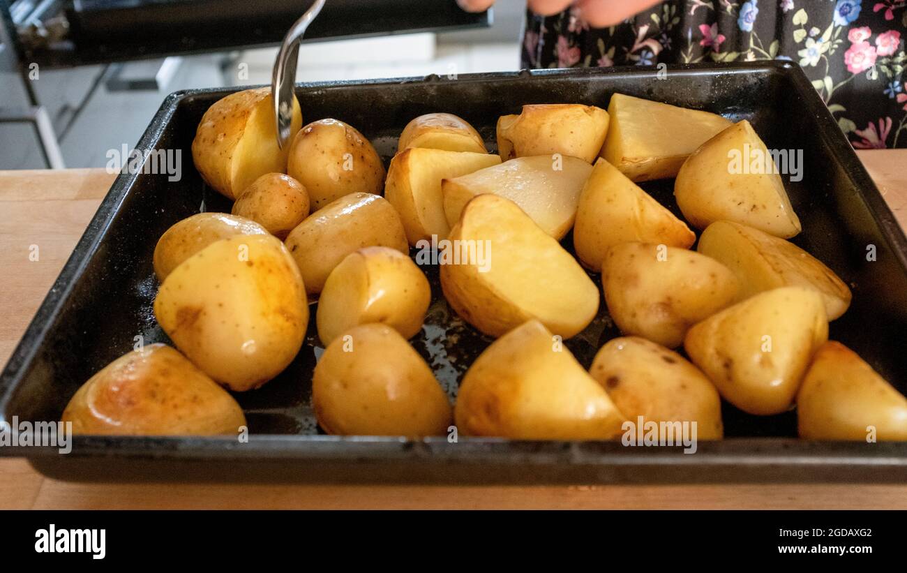 Half cooked roast potatoes Stock Photo - Alamy