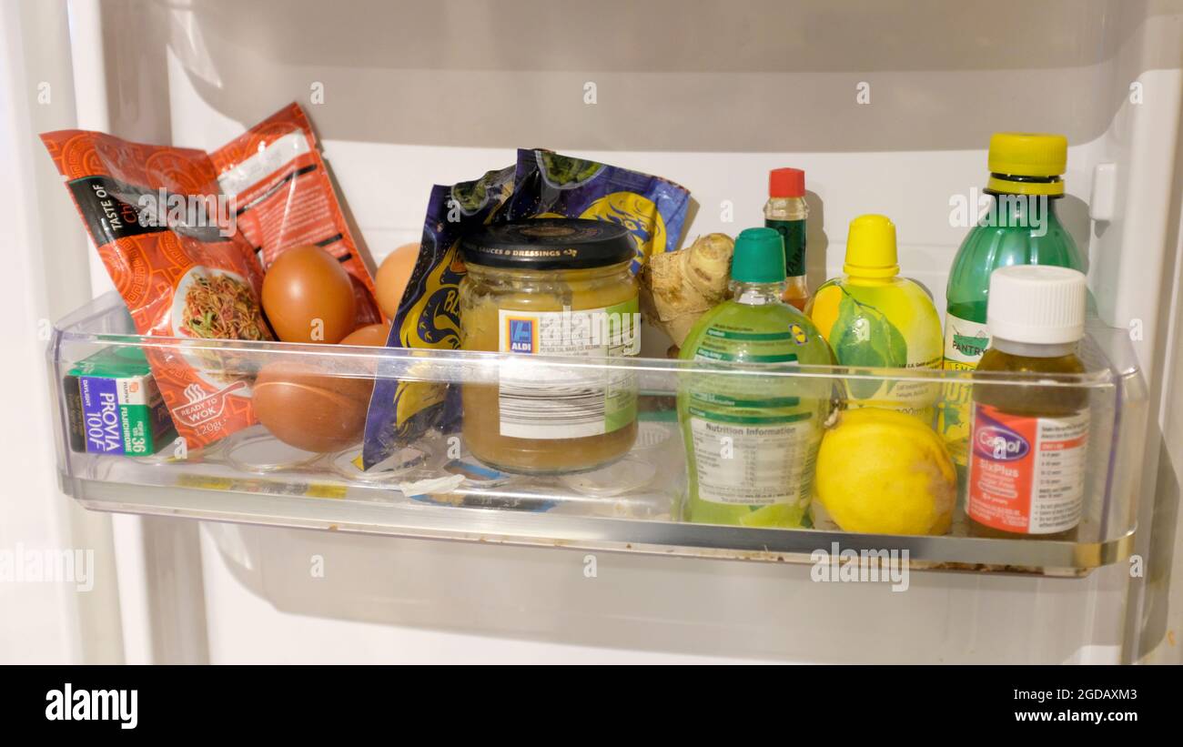 The contents of a very messy fridge door Stock Photo - Alamy