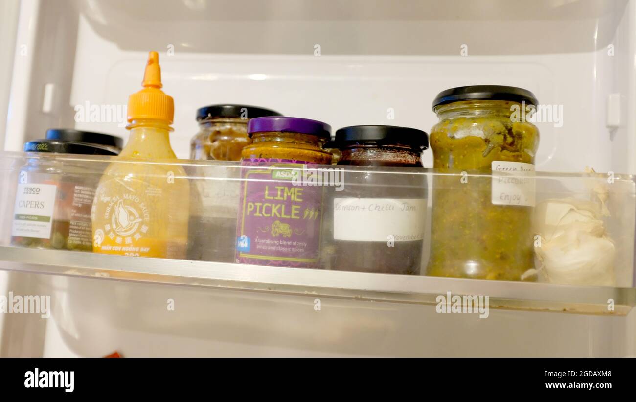 The contents of a very messy fridge door Stock Photo - Alamy