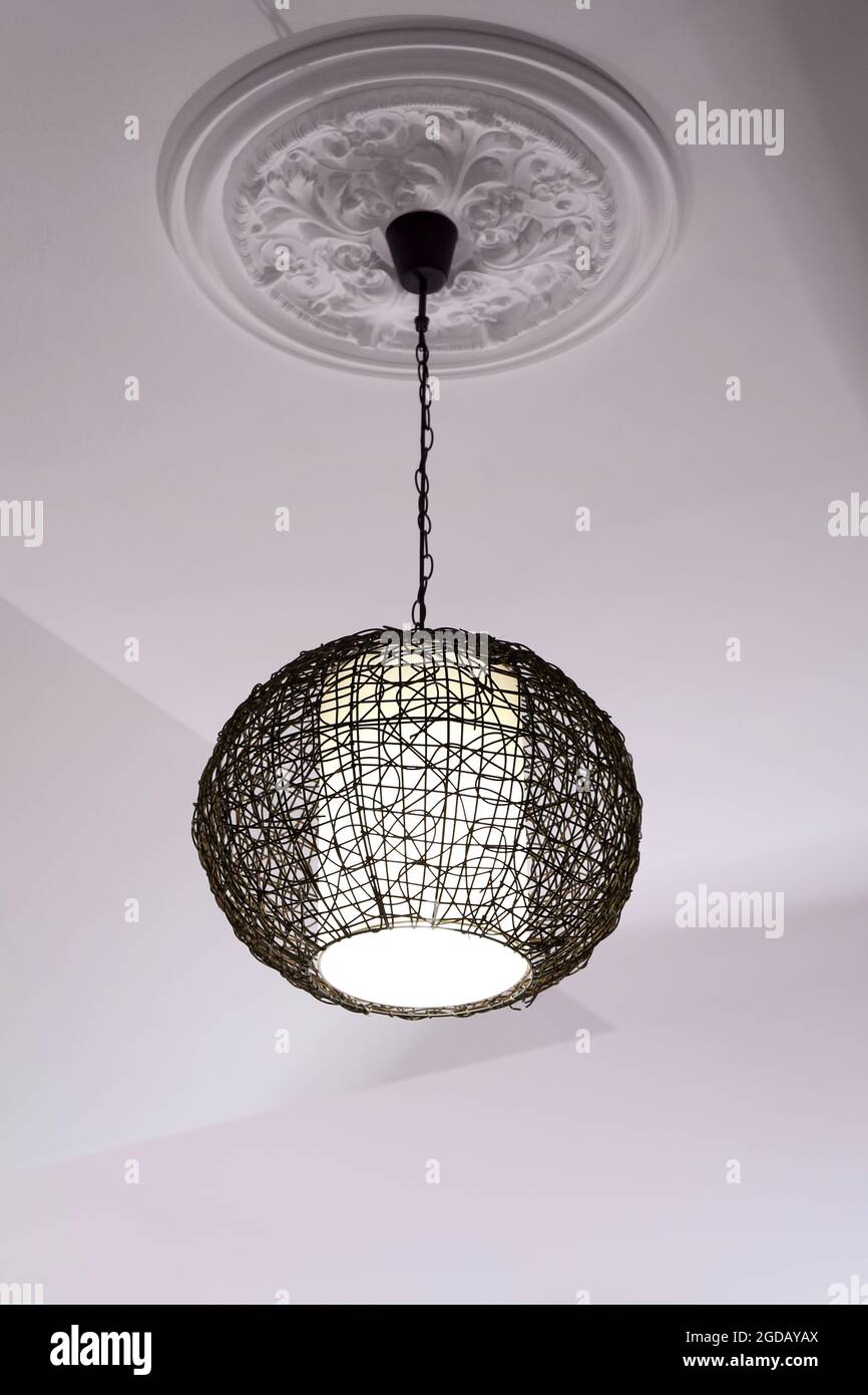 Modern chandelier hanging from ceiling Stock Photo - Alamy