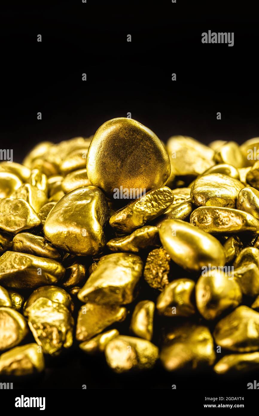 many gold nuggets on isolated black background, concept of wealth and ...