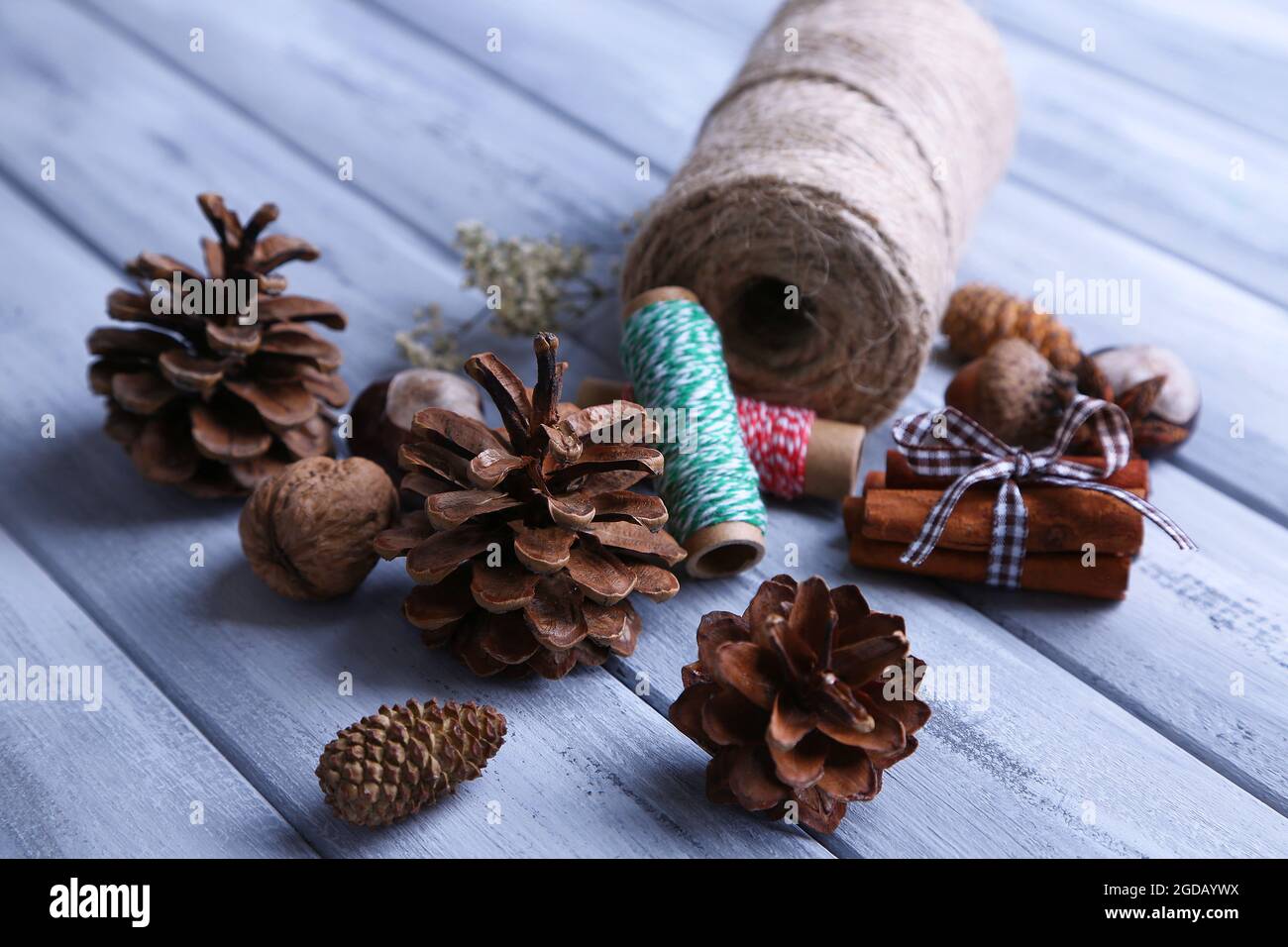 Composition with natural bump, thread, cinnamon sticks on wooden ...