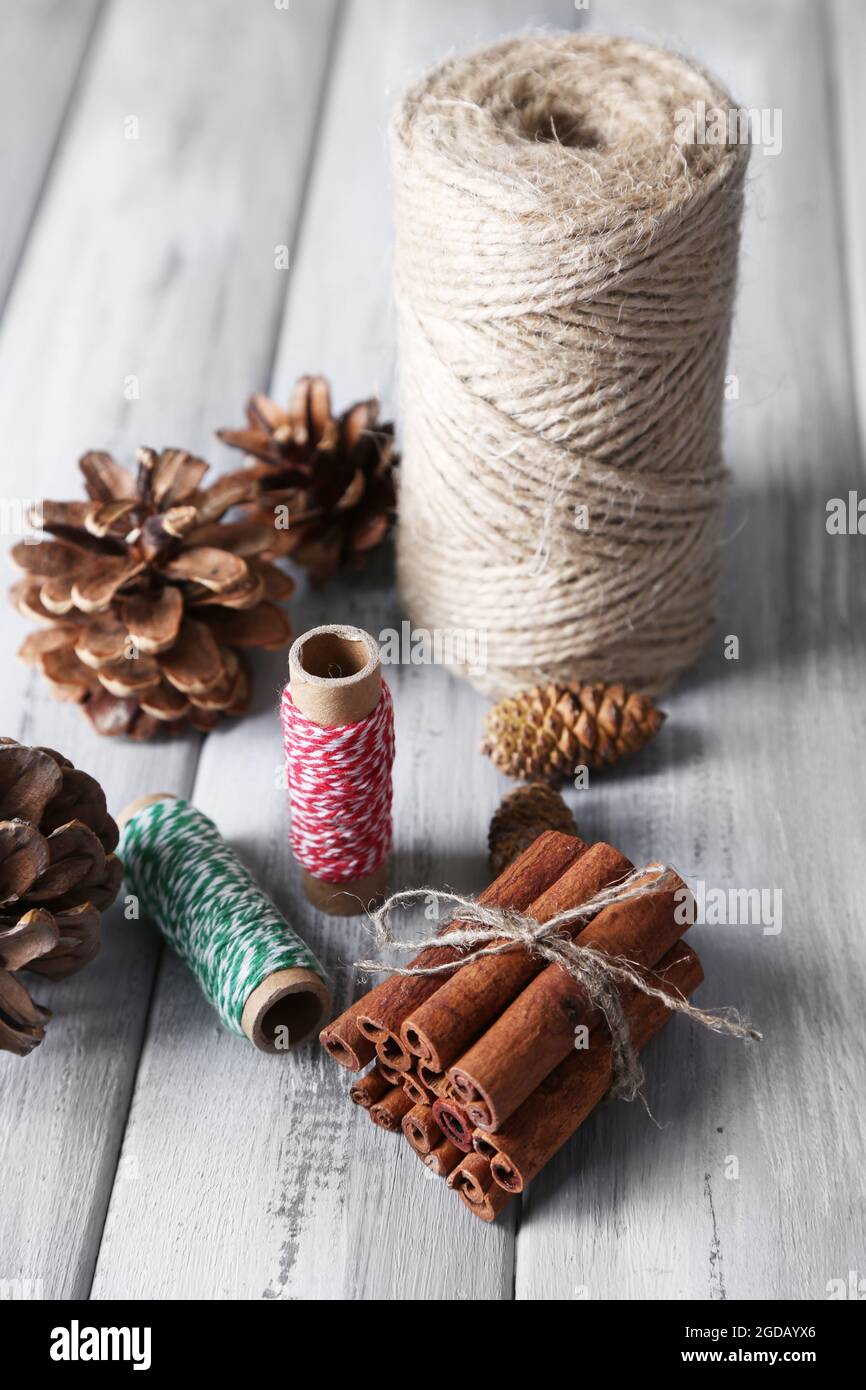 Composition with natural bump, thread, cinnamon sticks on wooden ...