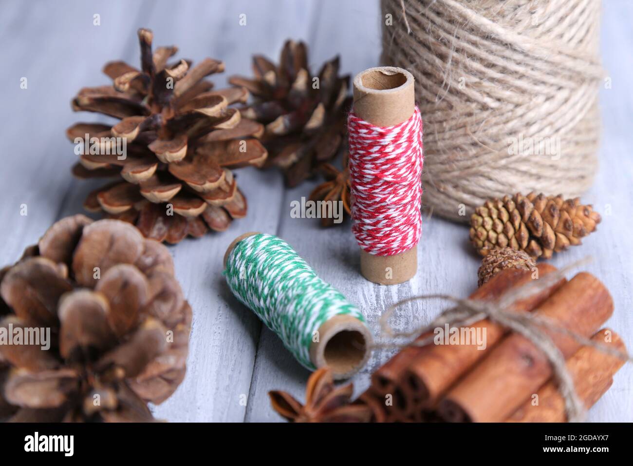 Composition with natural bump, thread, cinnamon sticks on wooden ...