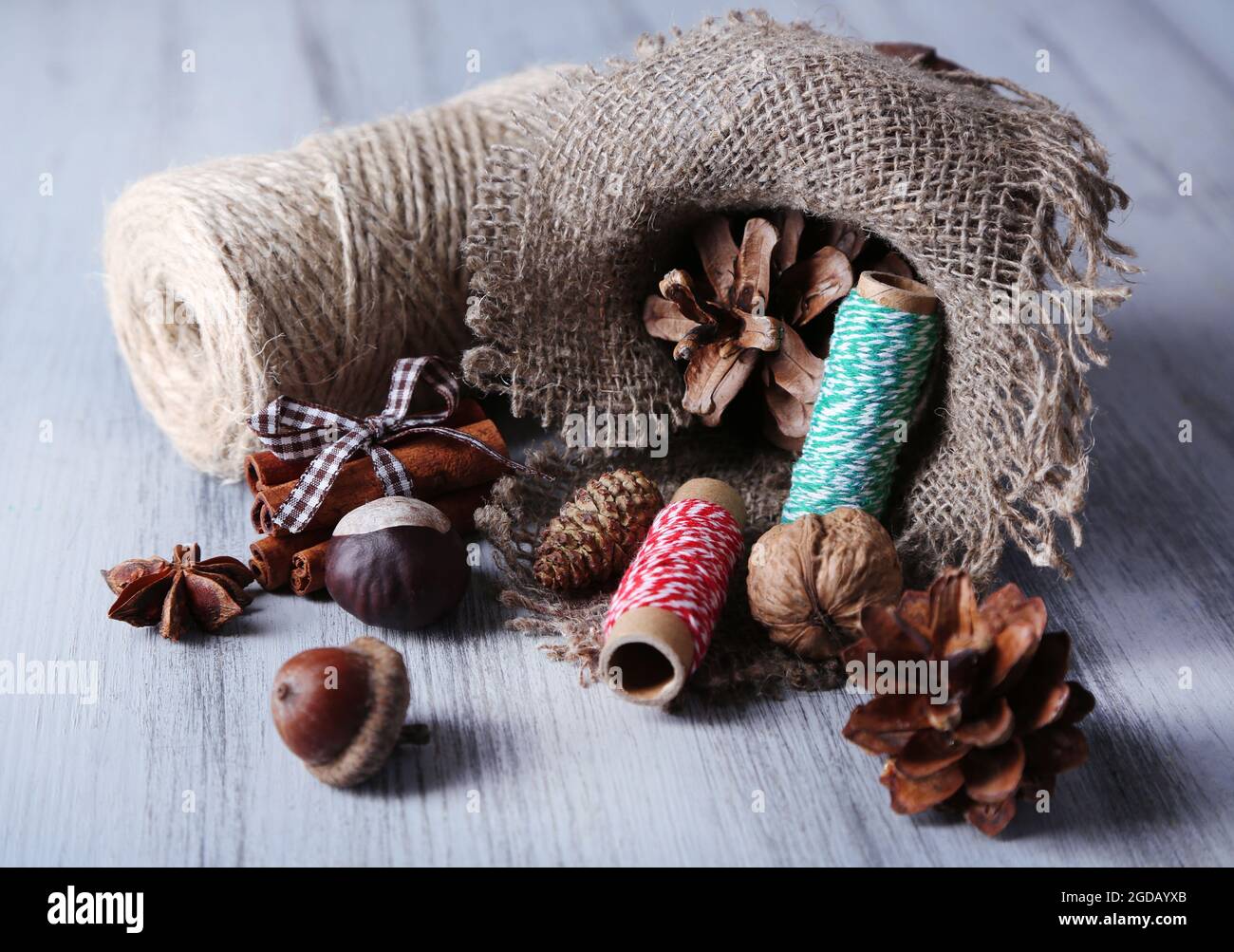 Composition with natural bump, thread, cinnamon sticks on wooden ...