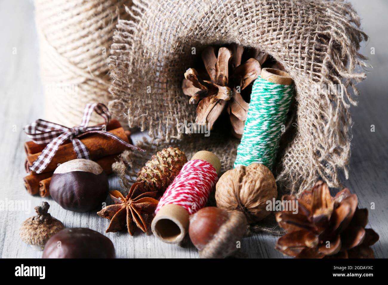 Composition with natural bump, thread, cinnamon sticks on wooden ...