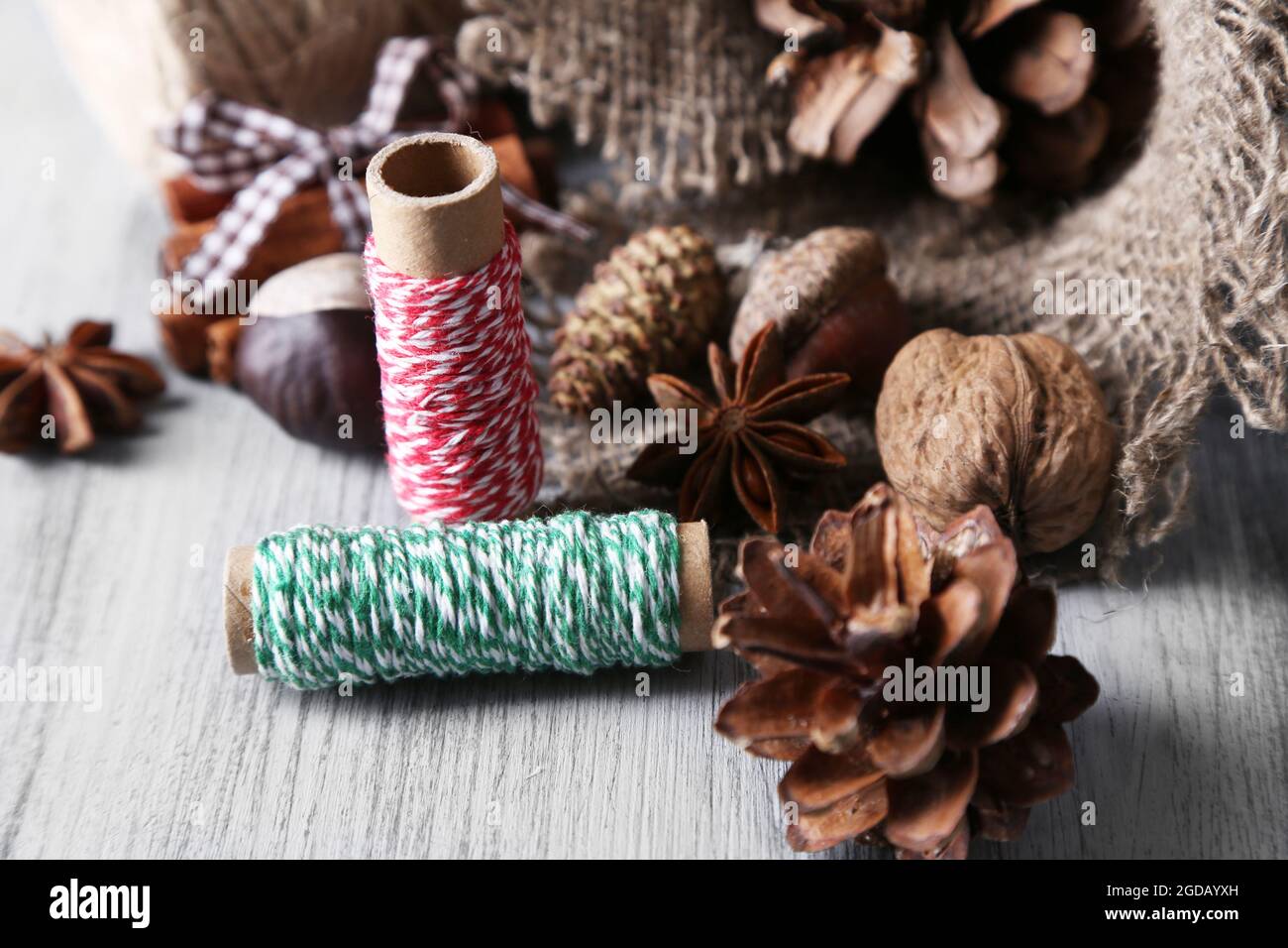 Composition with natural bump, thread, cinnamon sticks on wooden ...