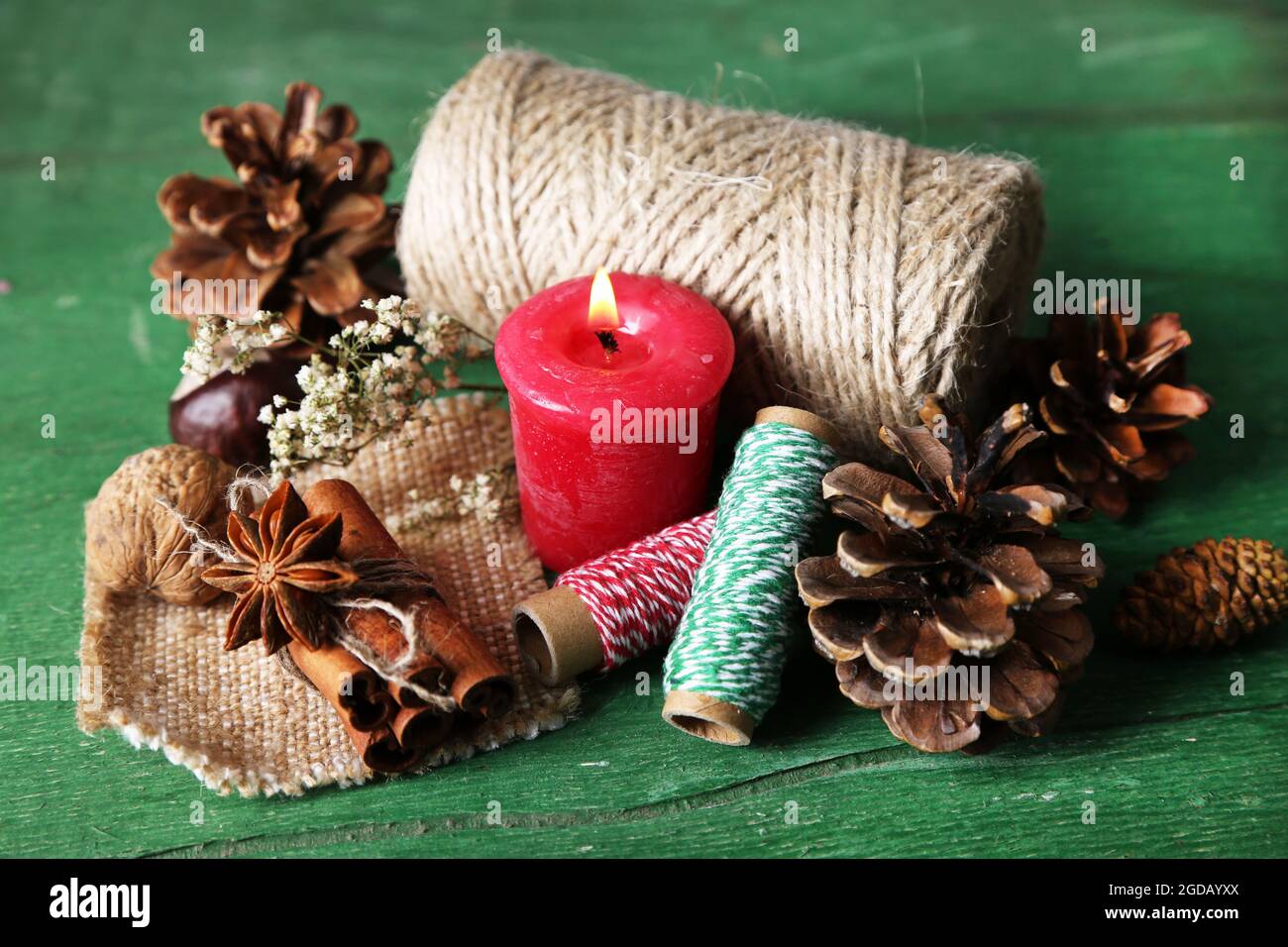 Composition with natural bump, candle, thread, cinnamon sticks on ...
