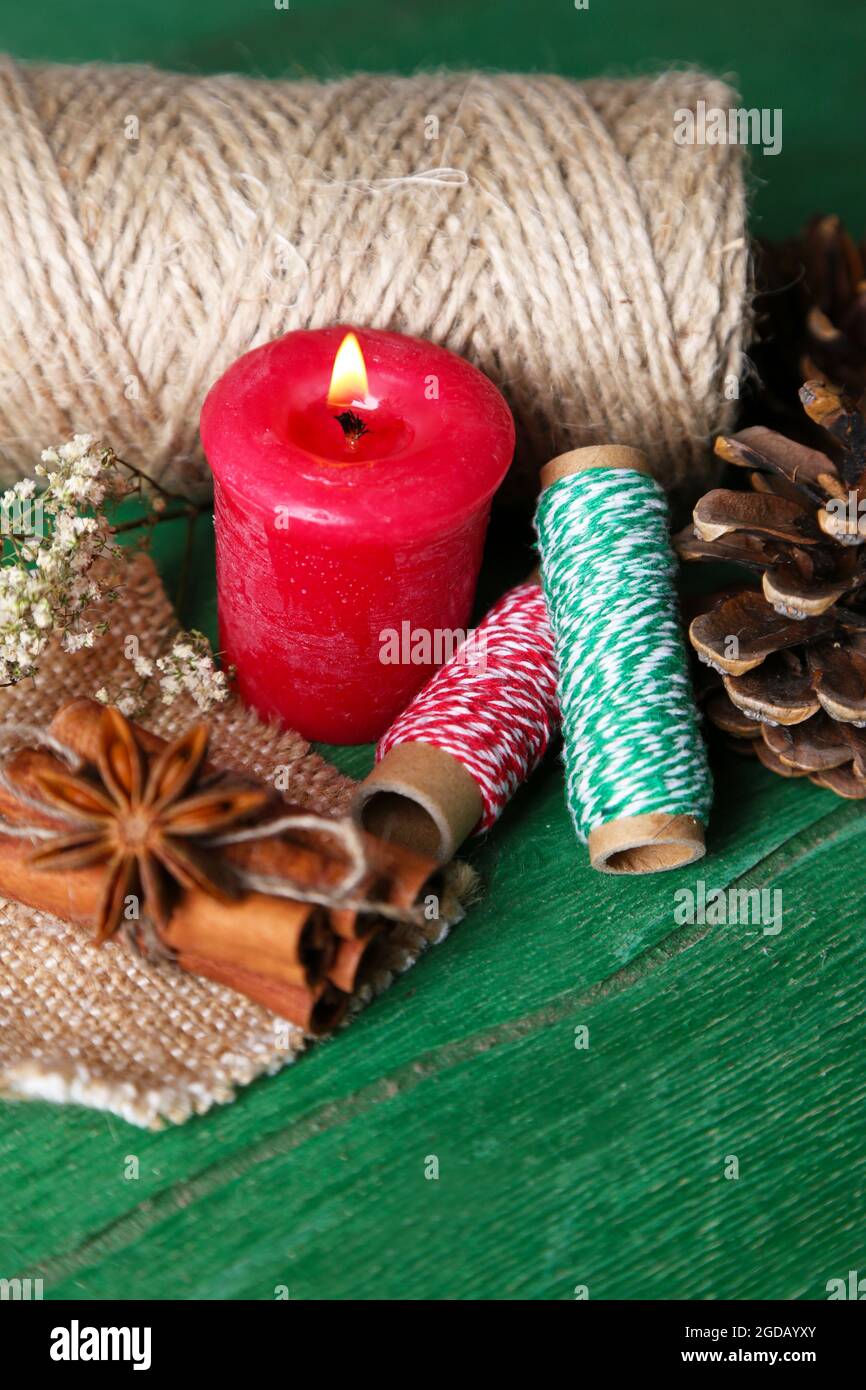 Composition with natural bump, candle, thread, cinnamon sticks on ...