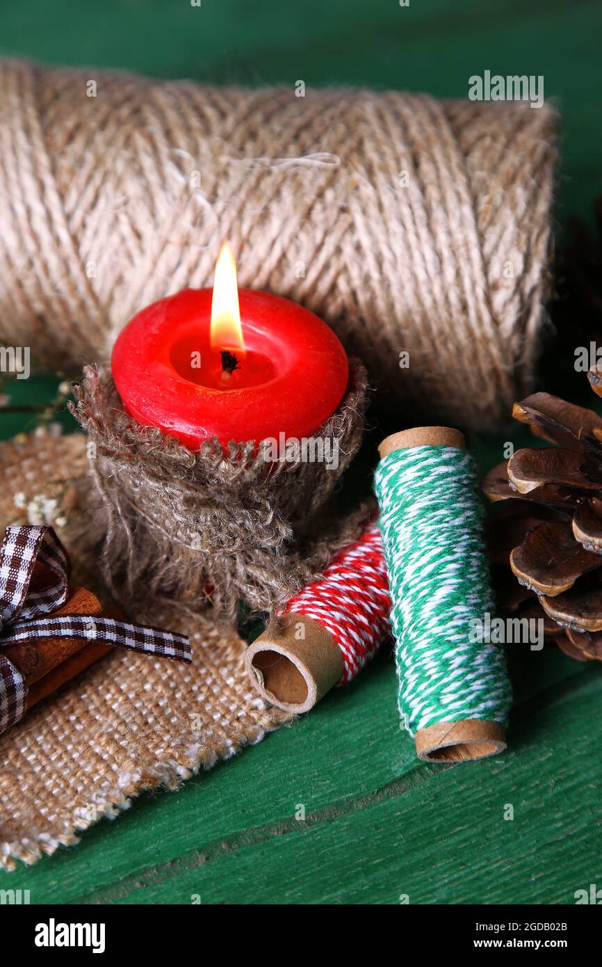 Composition with natural bump, candle, thread, cinnamon sticks on ...