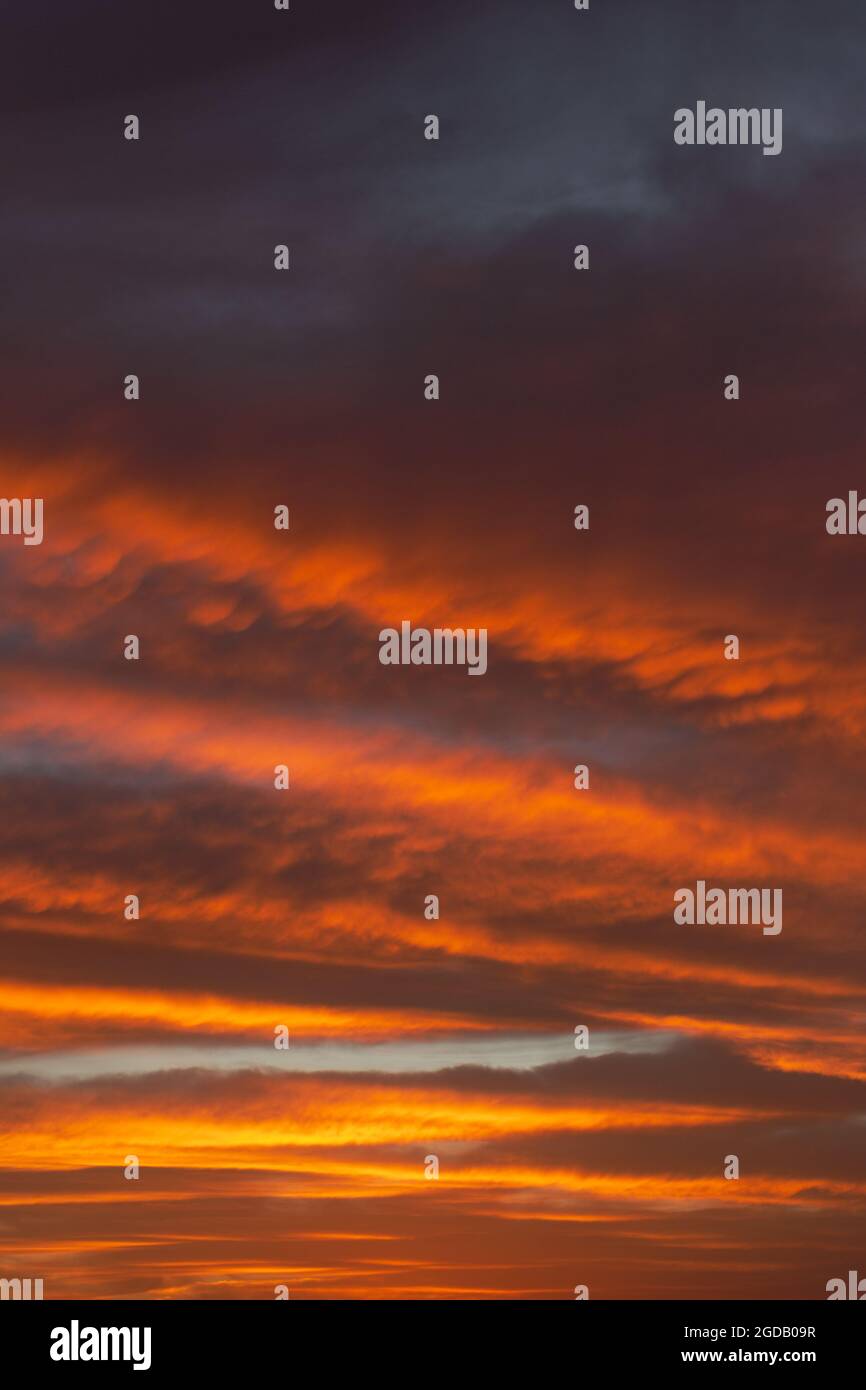 Sunrise sky with red color fire on a cloudy winter day Stock Photo - Alamy
