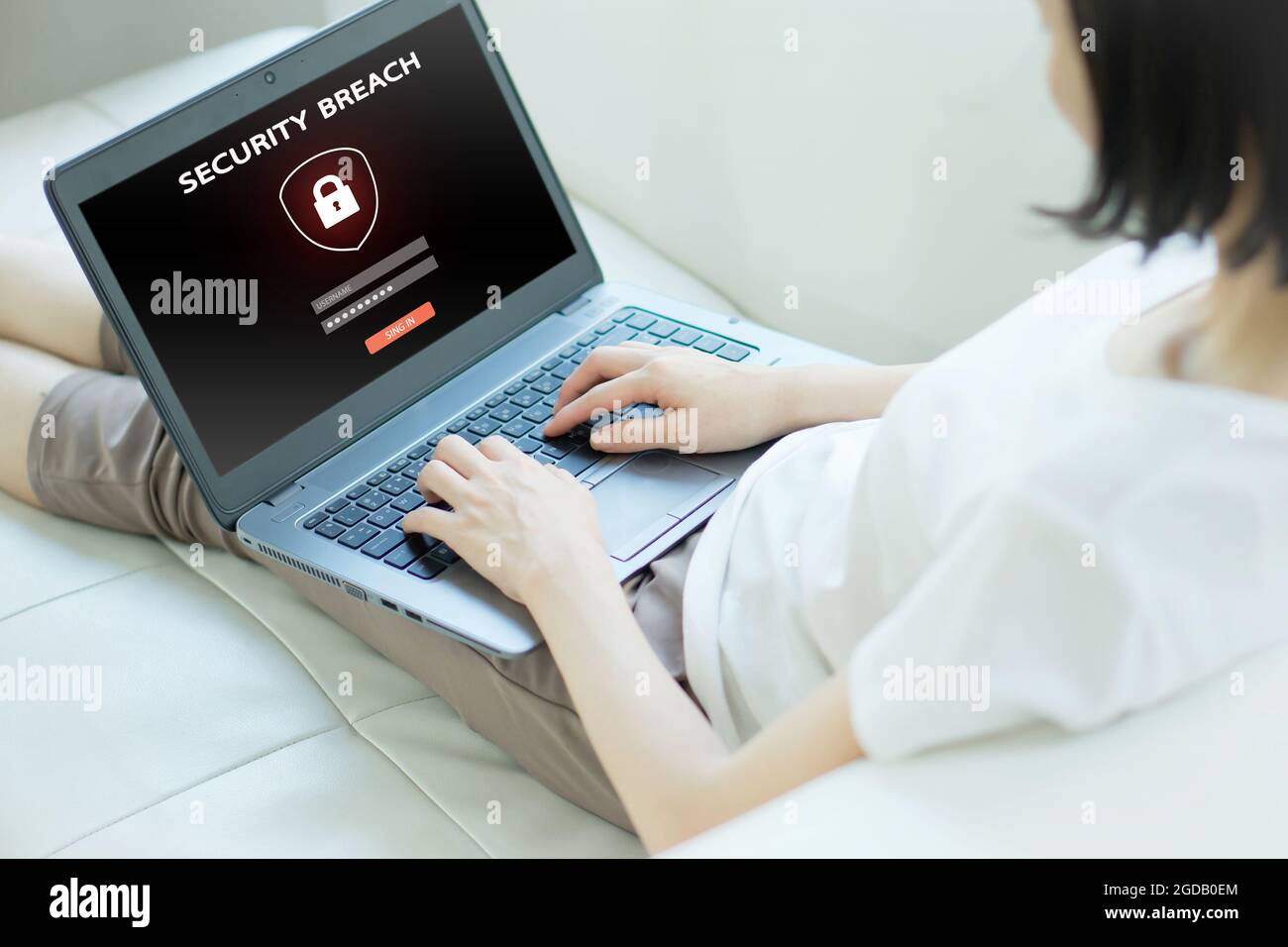 Hand tying laptop computer with password login on screen, cyber ...
