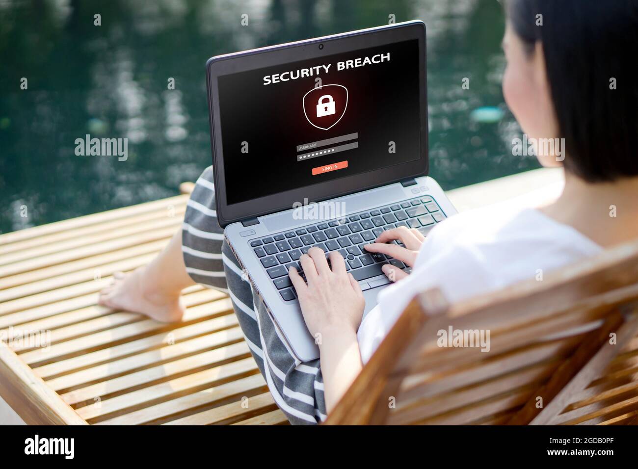 Hand tying laptop computer with password login on screen, cyber ...