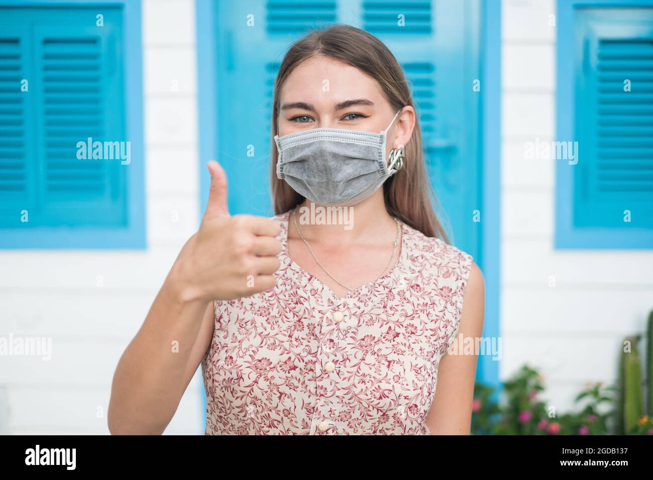 Portrait of caucasian young woman wearing disposable face mask ...