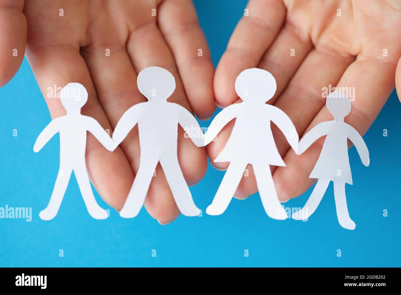 Human hands holding figurines of parents and children closeup Stock ...