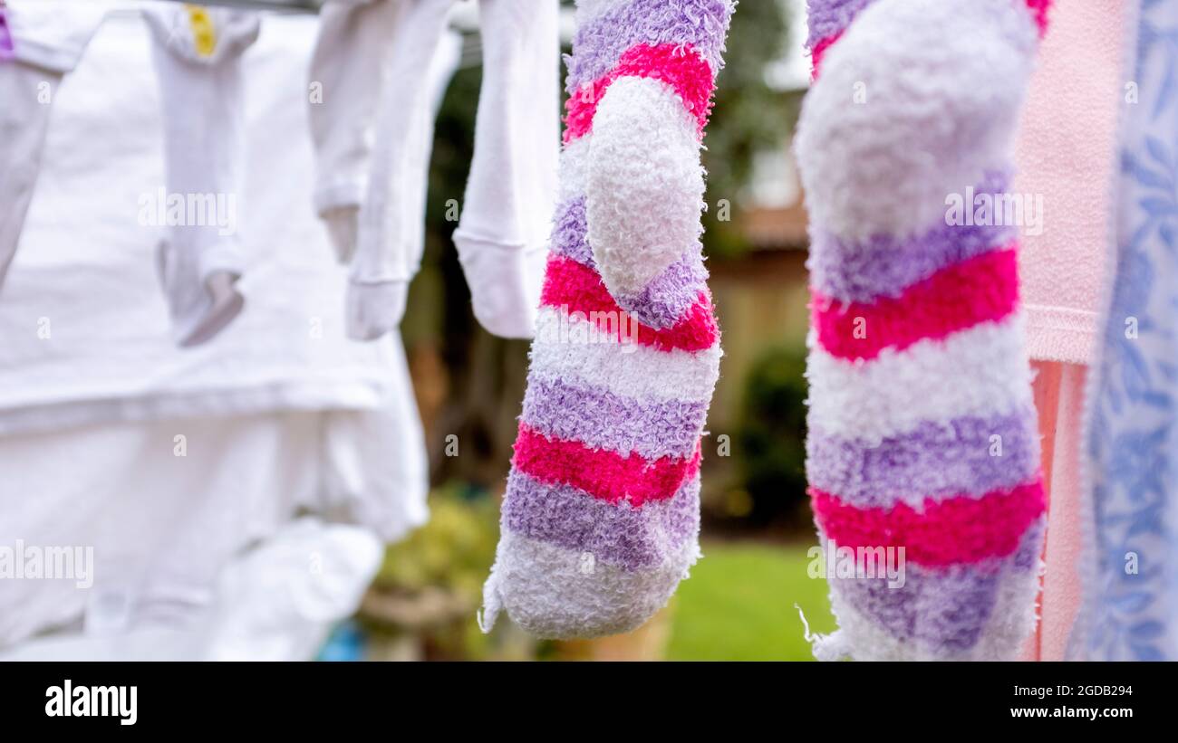 Washing on a washing line with an old pair of stripped socks in the ...