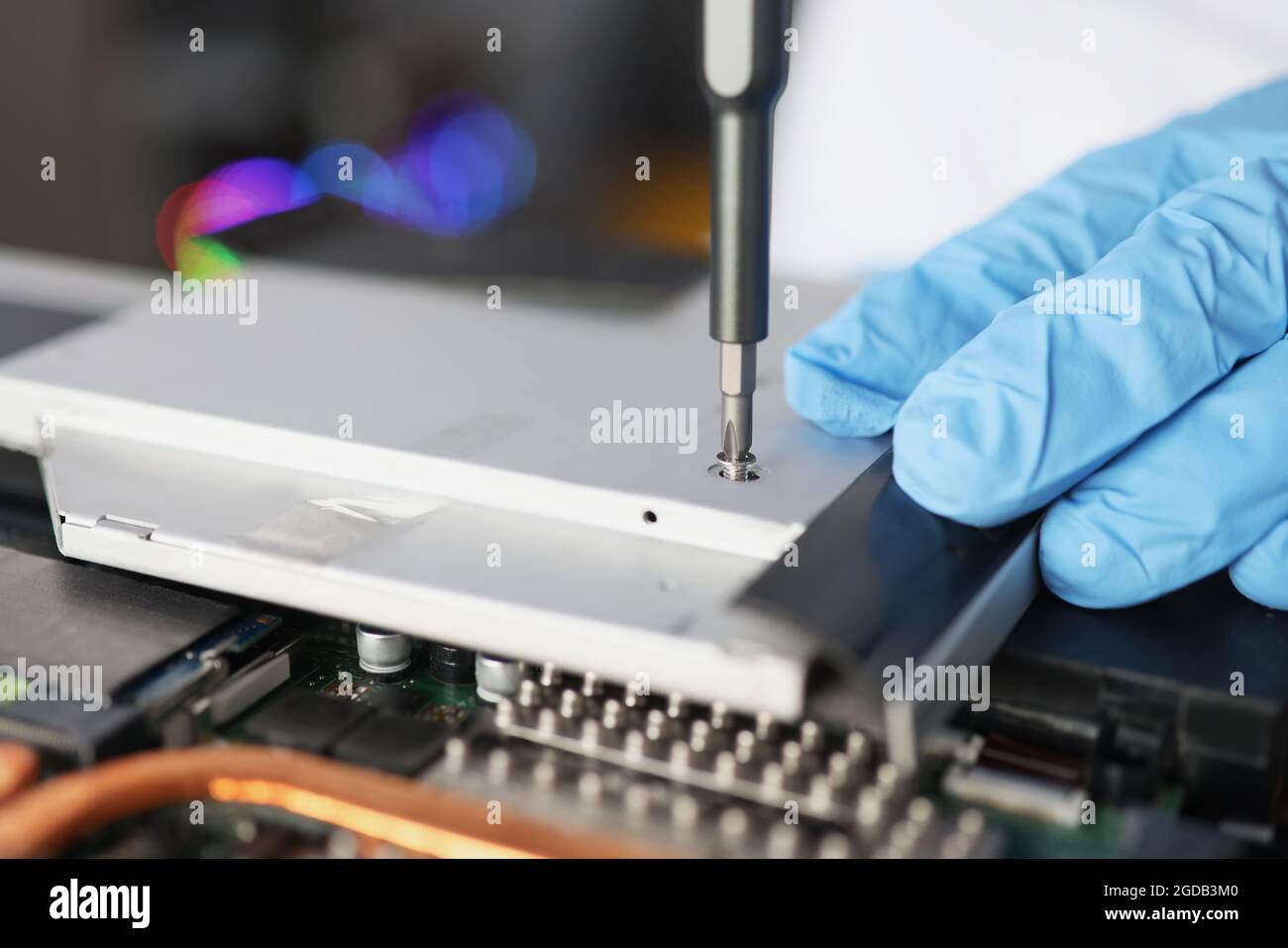 Master repairman in rubber gloves repairing computer equipment with ...