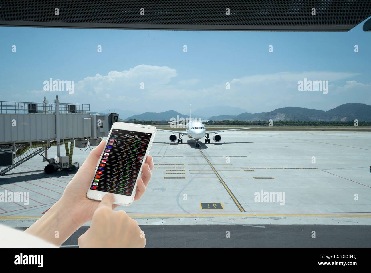 Hands holding mobile with currency exchange rates Stock Photo - Alamy