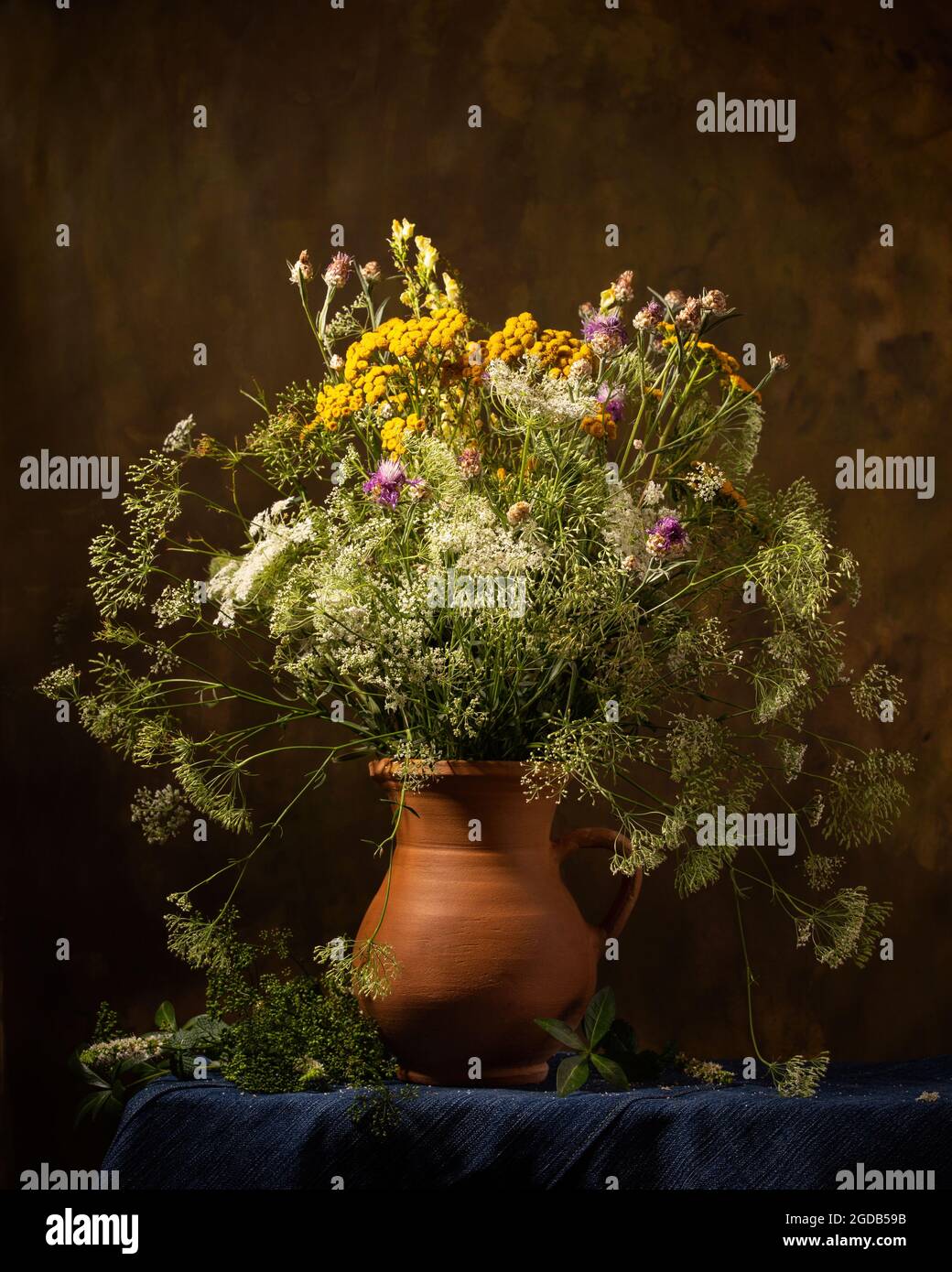 Still life with a bouquet of wildflowers in a ceramic jug Stock Photo ...