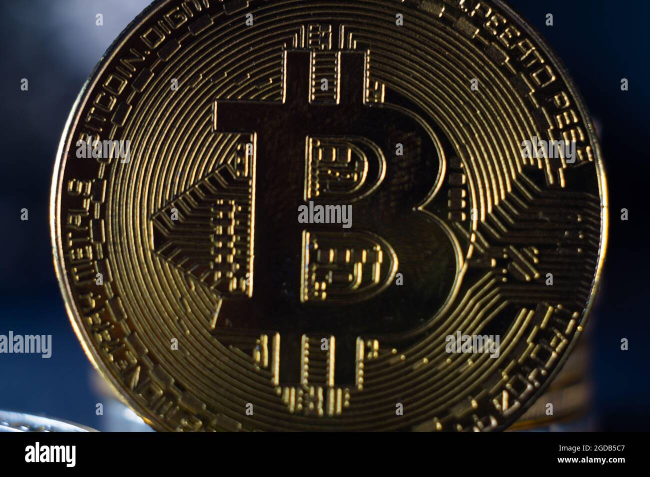 Coin with the Bitcoin on it on a blurred background Stock Photo - Alamy