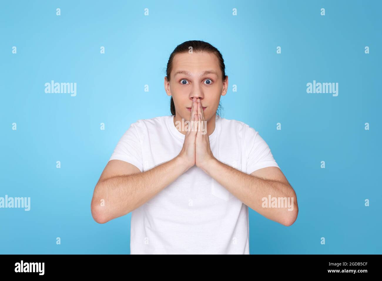 scared man in t-shirt isolated on blue background Stock Photo - Alamy