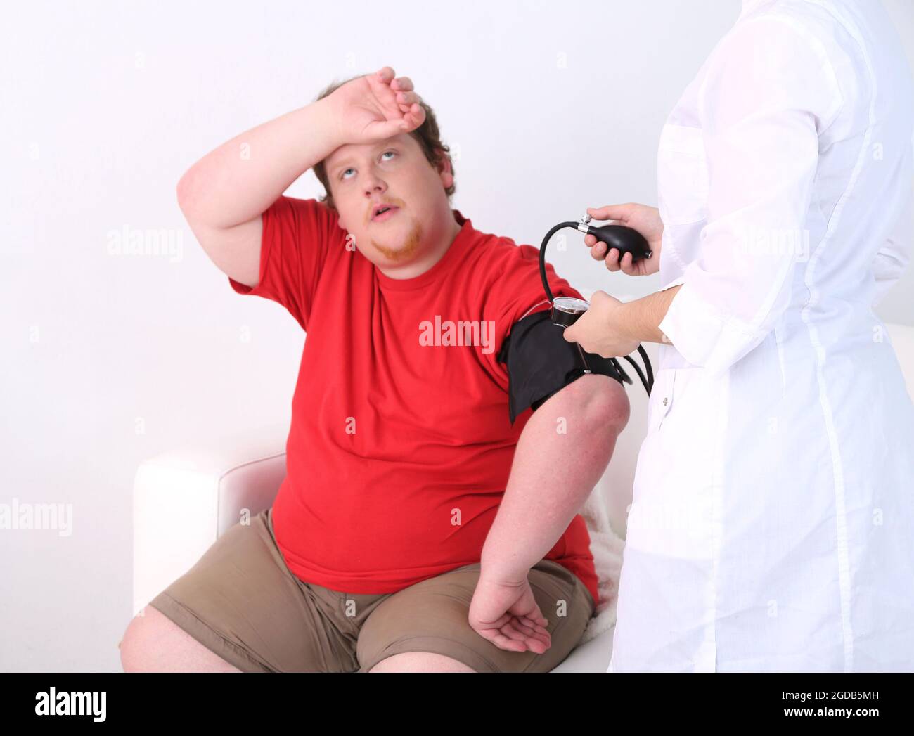 Doctor examining patient obesity on light background Stock Photo - Alamy