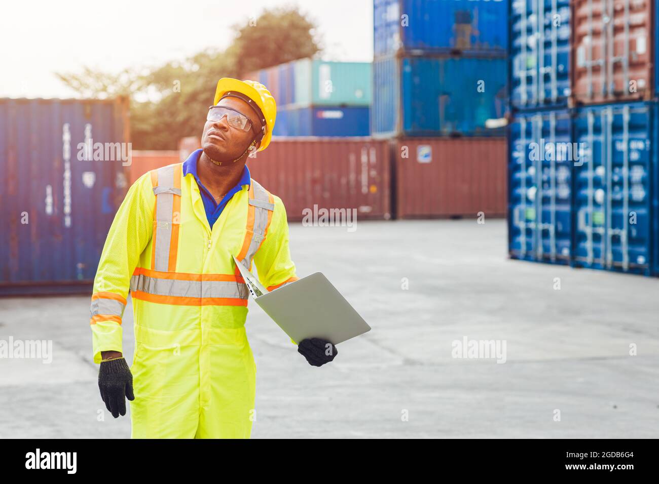 Black African happy worker working in logistic shipping with laptop ...