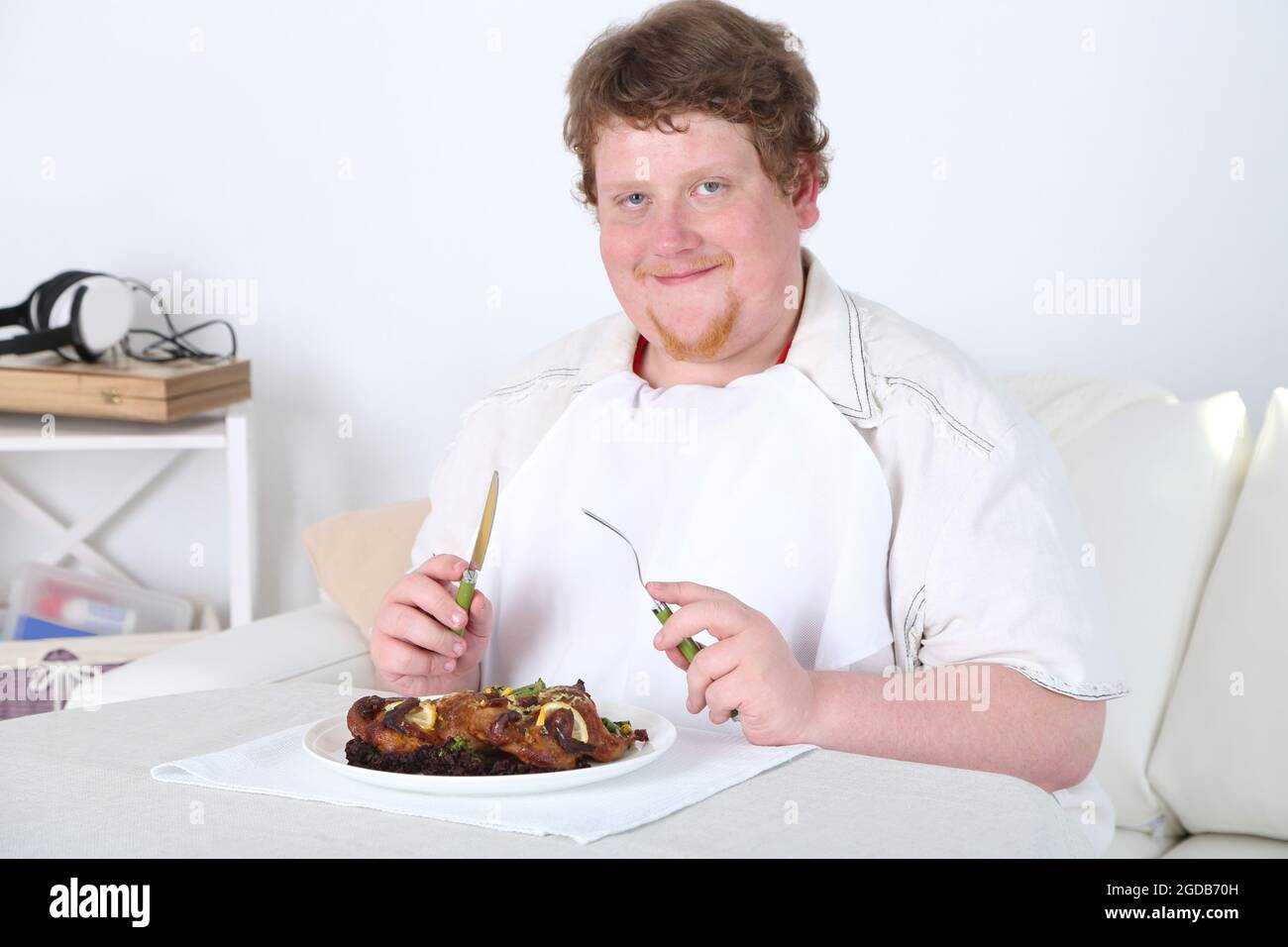 Tasty lunch for fat man, on home interior background Stock Photo - Alamy