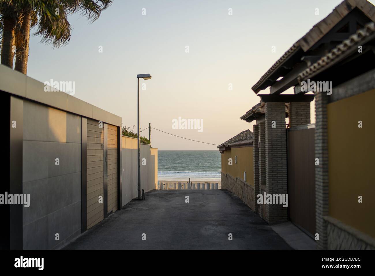 Beautiful view of a street with the view of the wavy sea under the blue ...