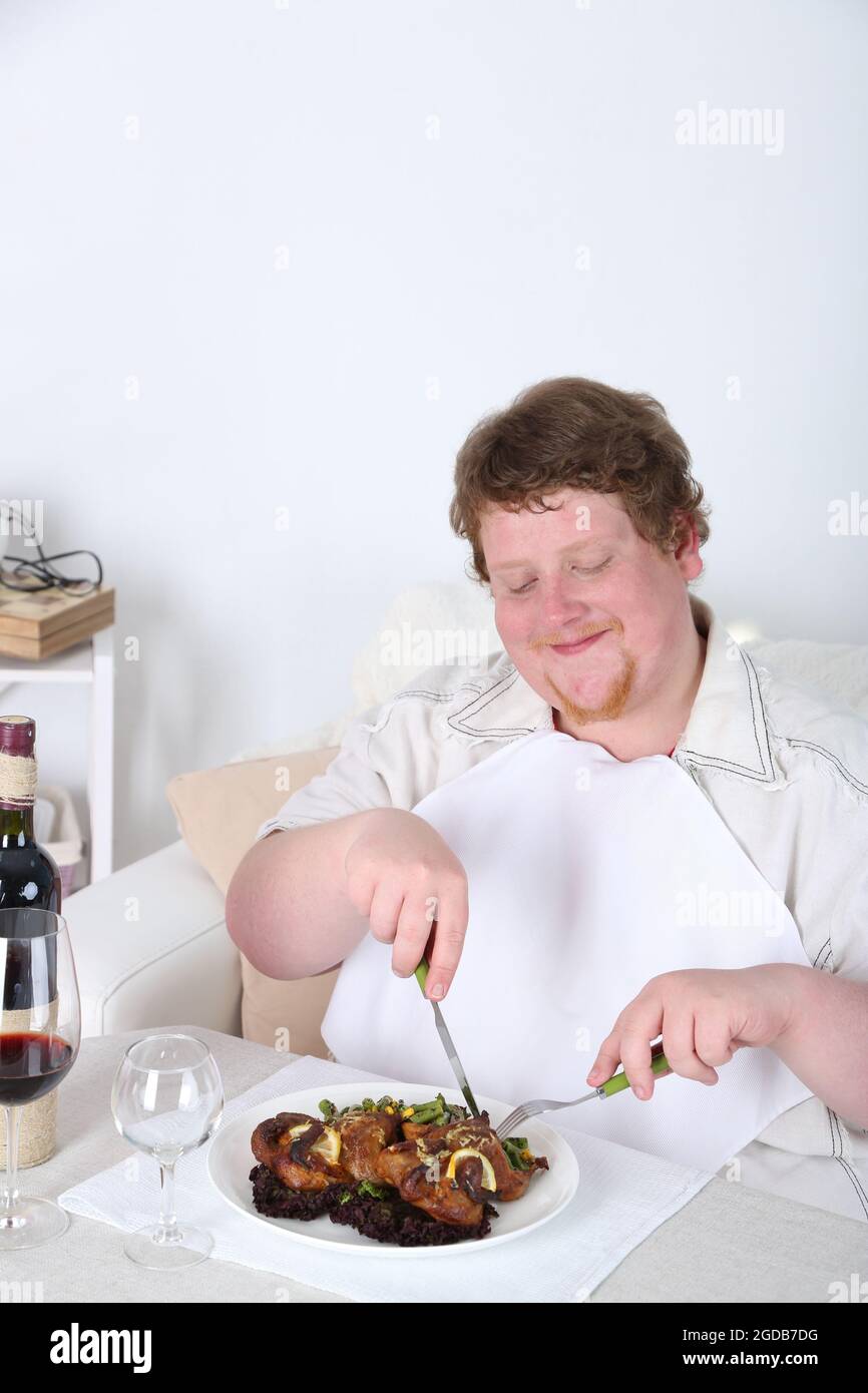Tasty lunch for fat man, on home interior background Stock Photo - Alamy
