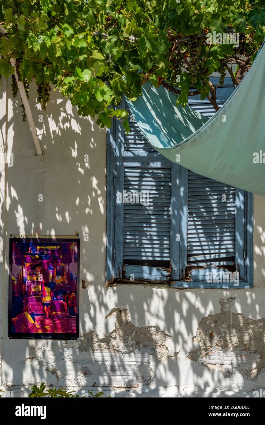 greek shutter in dappled sunlight, typical greek building with coloured ...