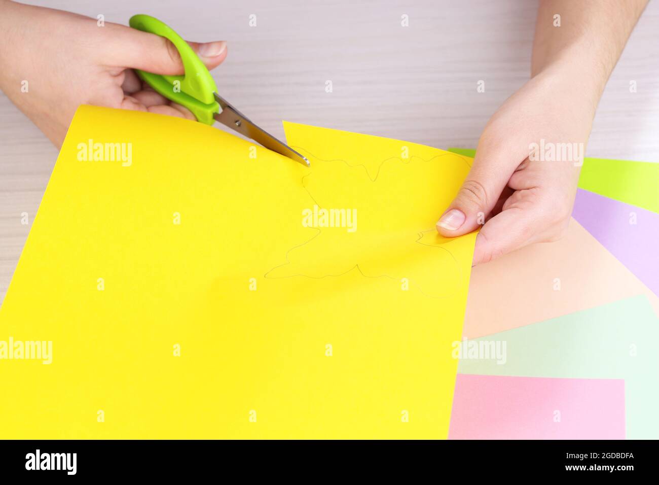 Women hand cutting colorful paper with scissors Stock Photo - Alamy