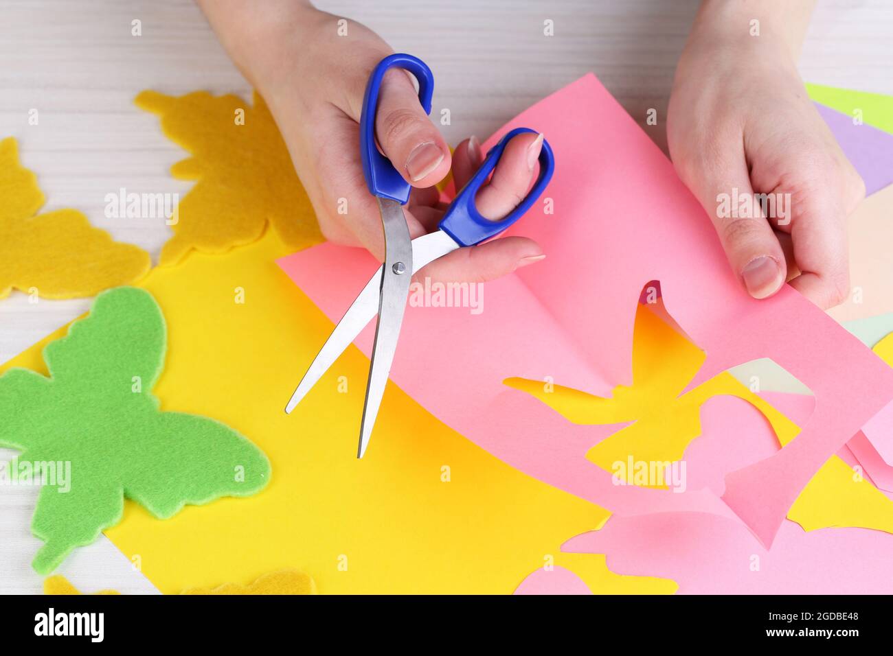Women hand cutting colorful paper with scissors Stock Photo - Alamy