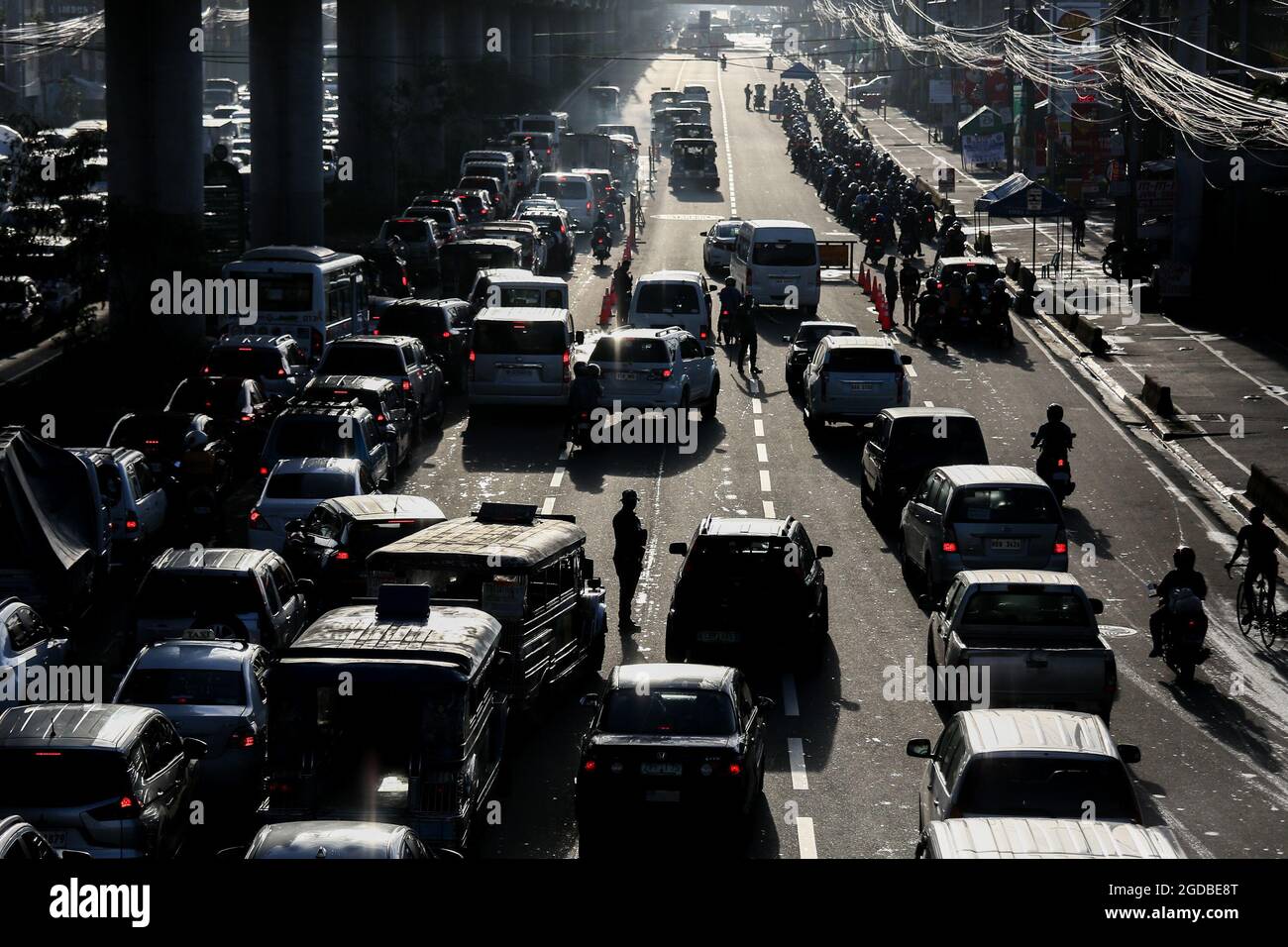 Policemen wearing protective equipment inspect motorcycle riders at a ...