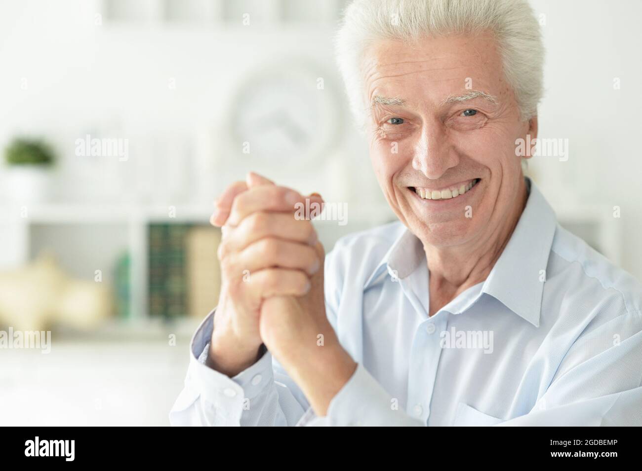 Senior man shaking hands isolated on white background Stock Photo - Alamy
